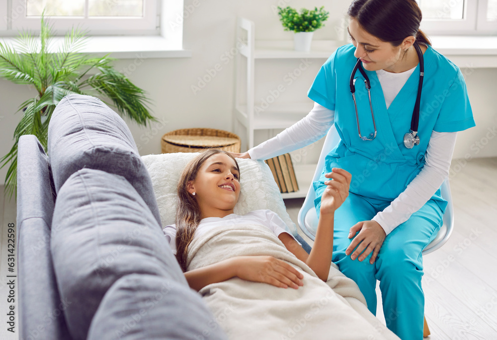 Doctor visits a sick child patient at home. Friendly woman pediatrician ...