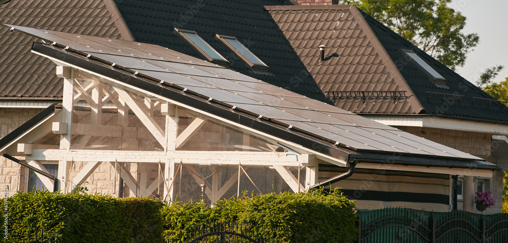 Solar panels on the roof of the modern house. Residential house cottage ...