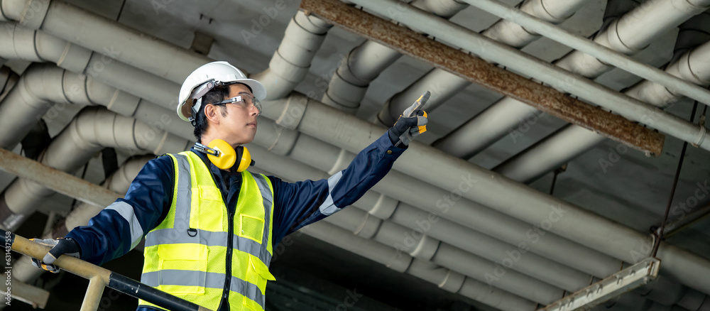 Asian male building inspection engineer pointing at plumber piping ...