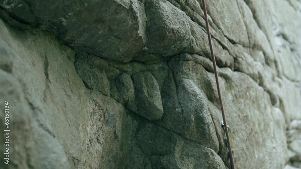 young slim muscular woman rockclimber climbing on tough sport route ...