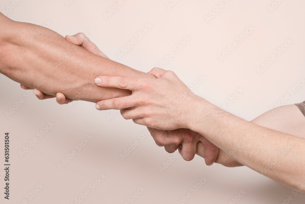 Two hands hold on to one hand that saves and pulls upwards, helping one ...