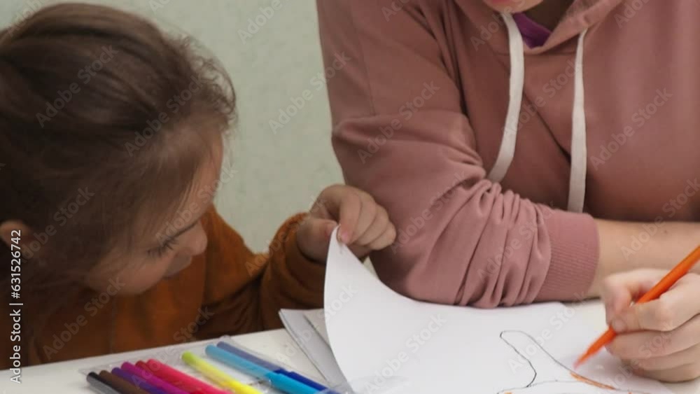 Little girl taking online art class with mother helping her at home ...