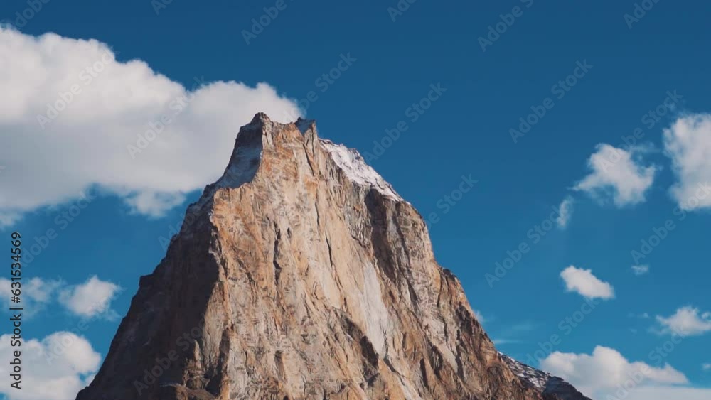 Handheld shot of clouds above the holy Gonbo Rangjon mountain during ...
