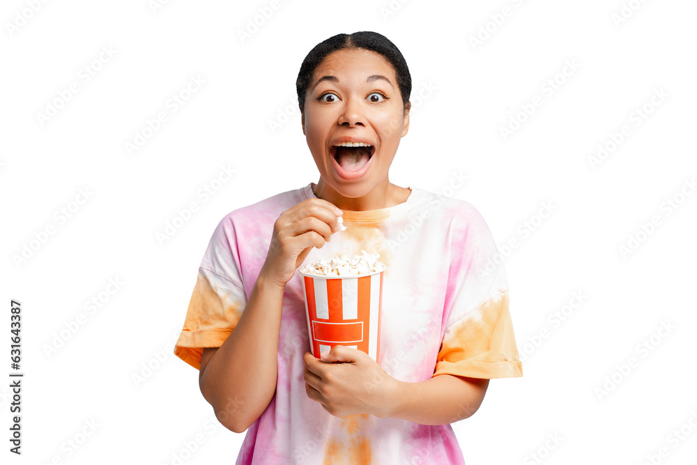Overjoyed African American woman holding bucket with popcorn, eating ...