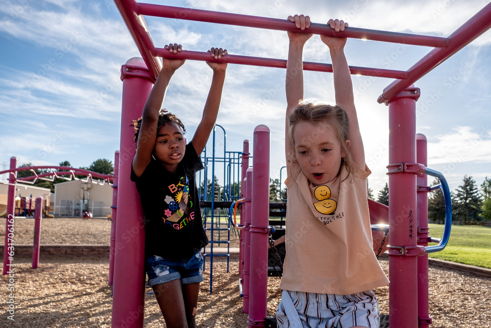 School aged children playing on monkey bars Stock Photo | Adobe Stock