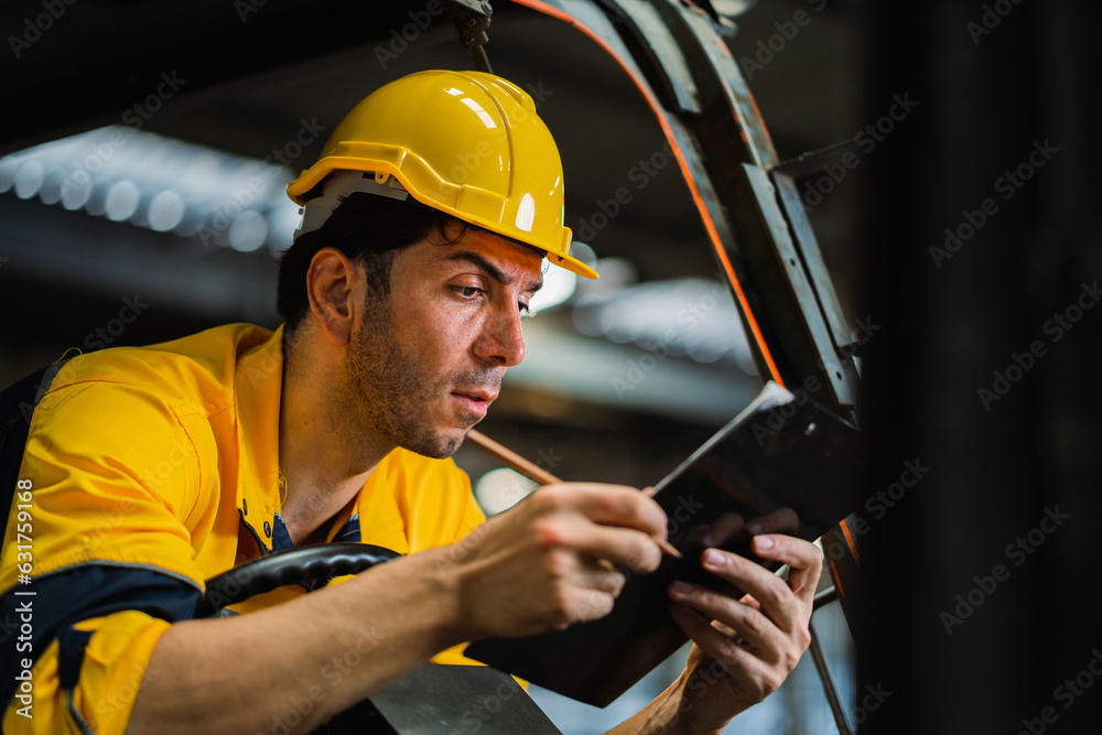 factory worker driving and operating a forklift in an industrial ...