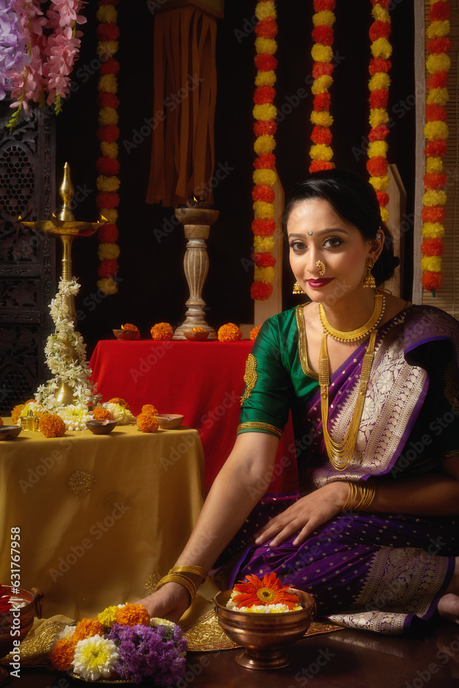 Foto de Portrait of Indian young lady performing Hindu rituals of pooja ...