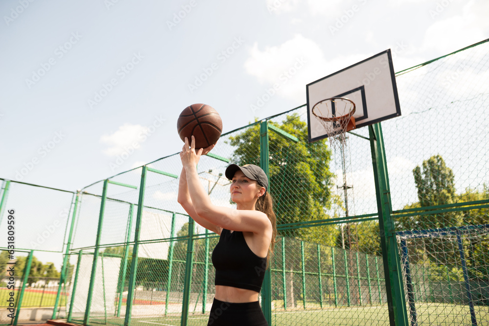 Athletic female basketball player throwing a ball up to the net. Stock ...