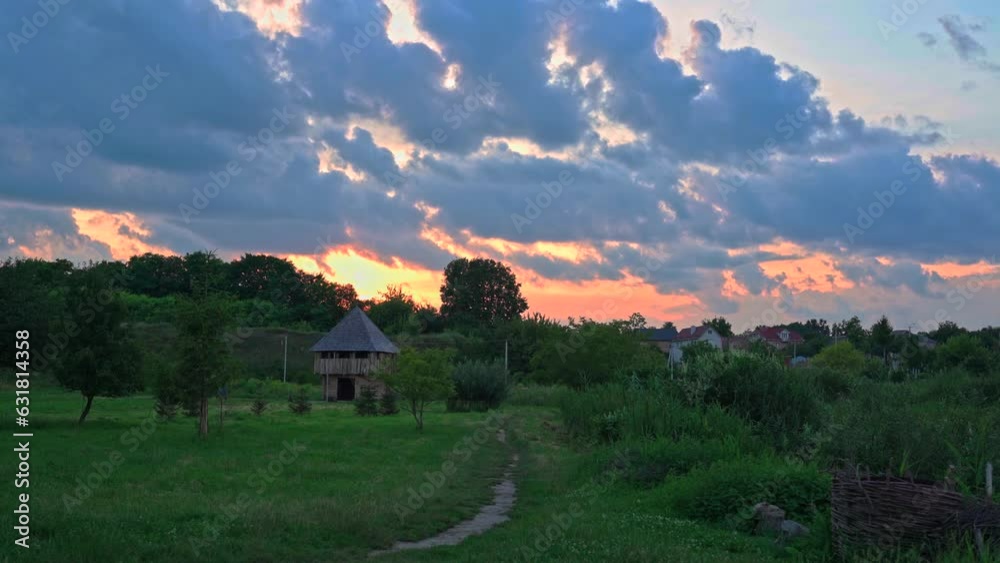 Village houses at sunset in summer. Beautiful cloudy sky view with ...