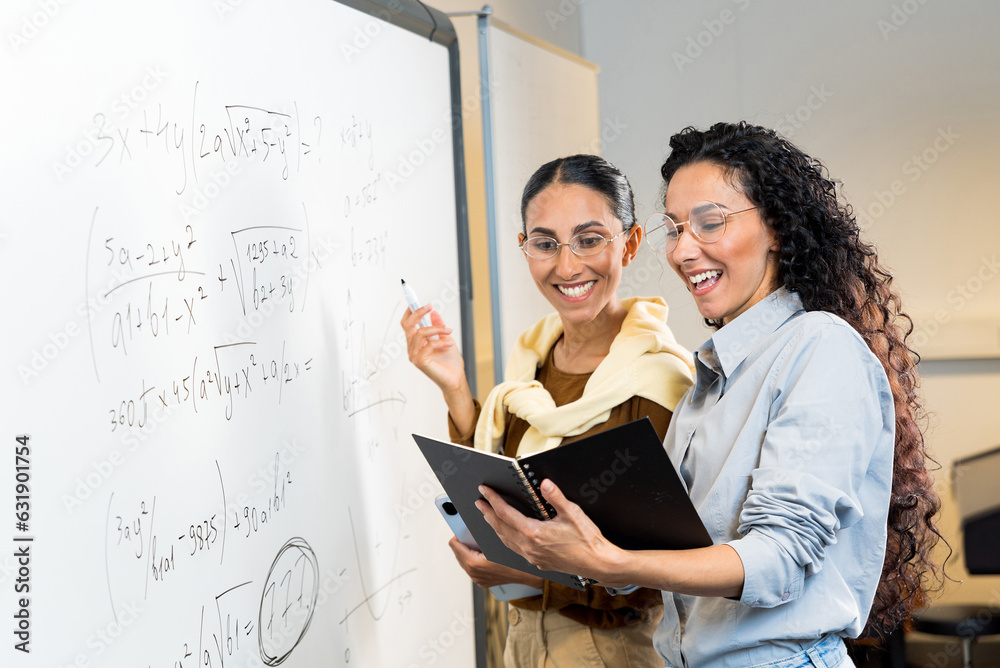Two beautiful female students of Eastern appearance stand in a ...