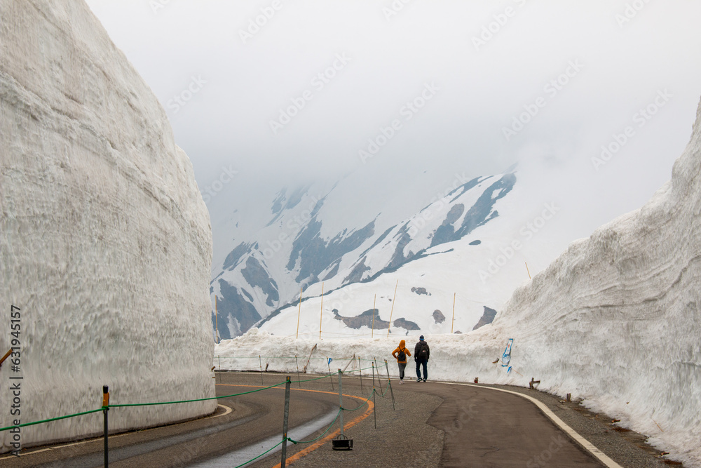 Snow walls along Tateyama Kurobe Alpine Route partially hidden by the ...