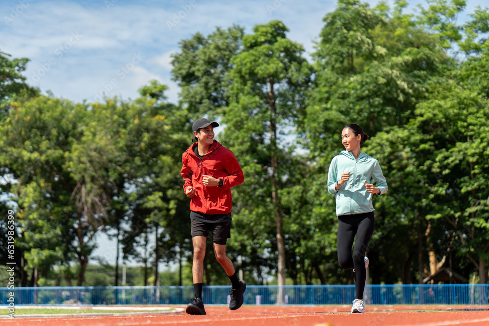 Asian Couple jogging and running outdoors at sport stadium. Happy Man ...