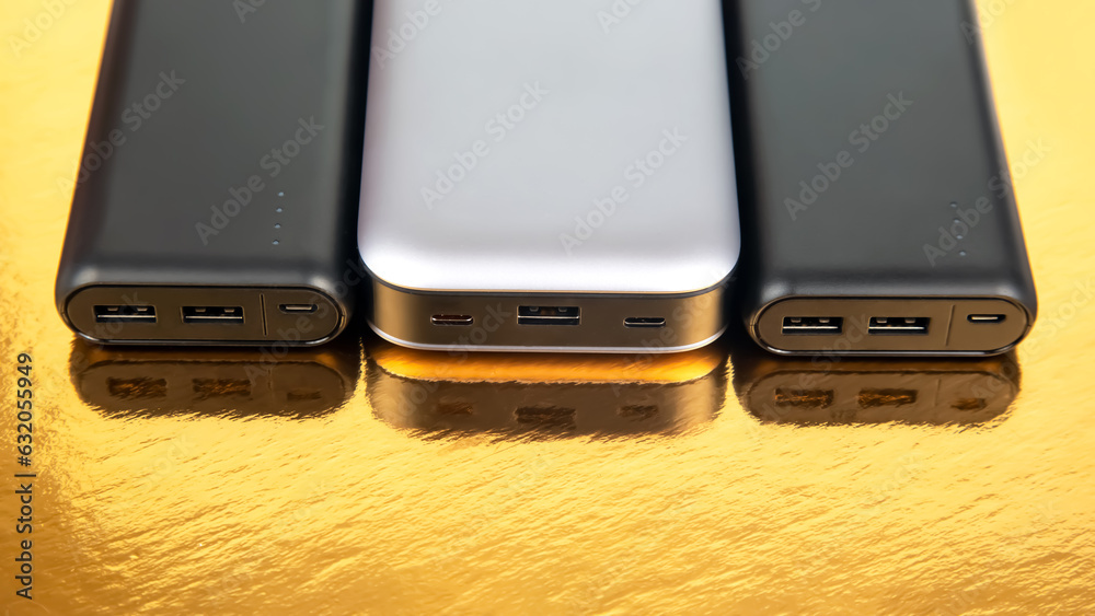 Powerbank portable on a golden background. Electronic devices for ...