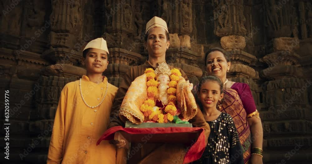 Portrait of Happy Indian Family Looking at the Camera, Holding a Statue ...