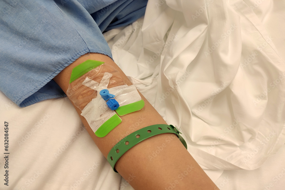 Vascular access bandage. Patient arm with a peripheral venous access ...