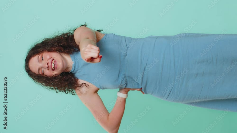 Amused lovely woman pointing finger to camera, laughing out loud ...