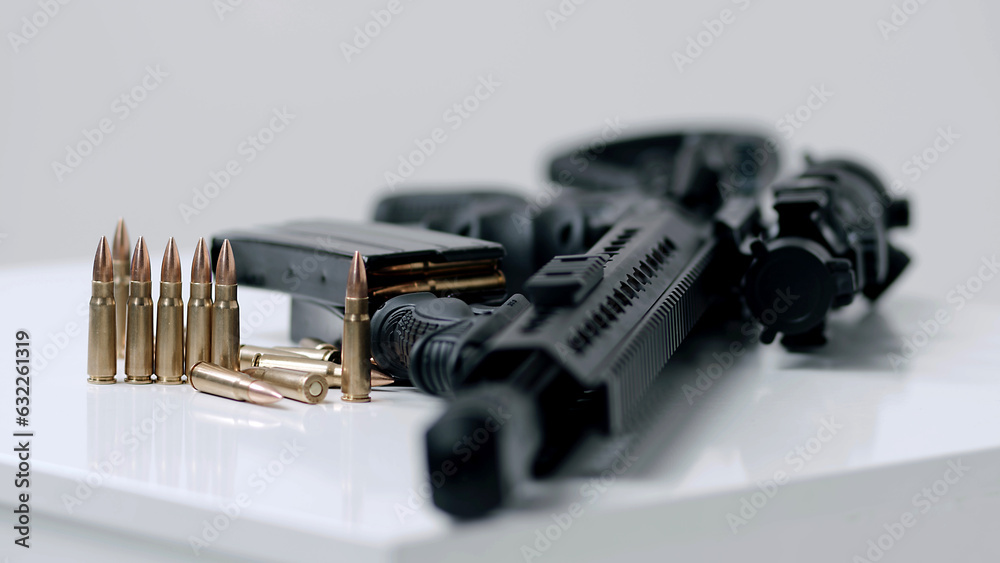 High angle dolly in towards loaded assault rifle with a small amount of ...