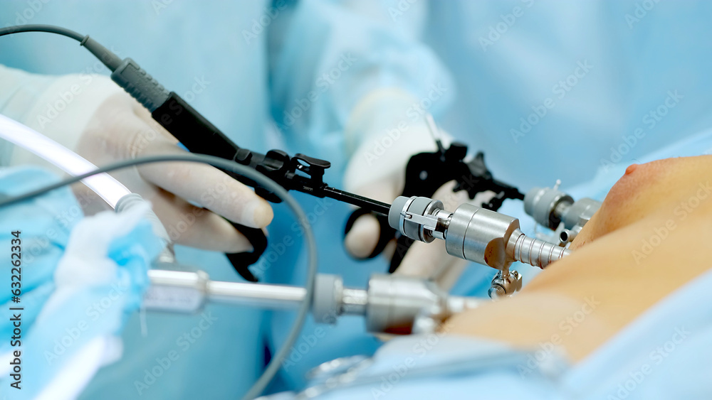 Close up of hands of surgeons team during operation uterus removal with ...
