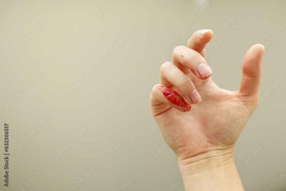 Female hand with red blood, little finger is bleeding profusely. Woman ...