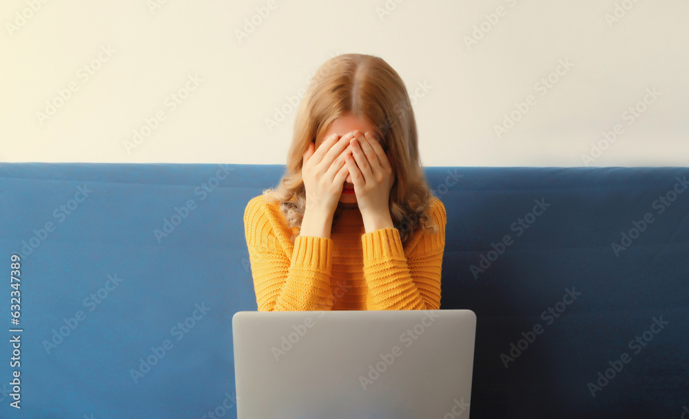 Sad upset emotional crying young woman while working with laptop ...