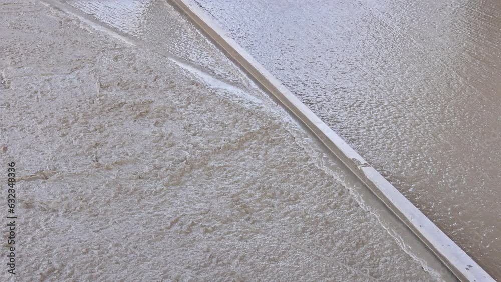 Workers leveling concreting for driveway on construction site using ...