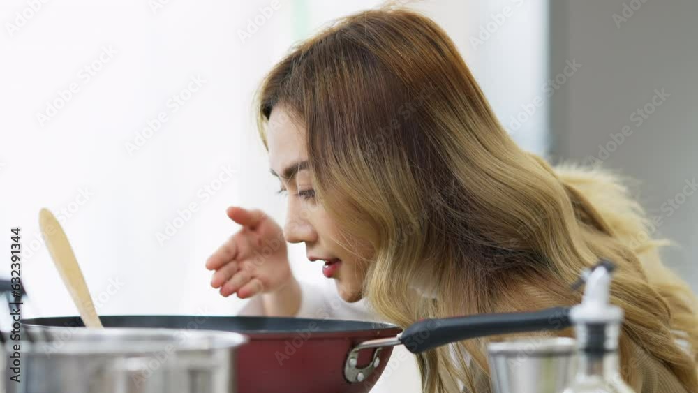 Asian woman cooking healthy food fried pasta in cooking pan on modern ...