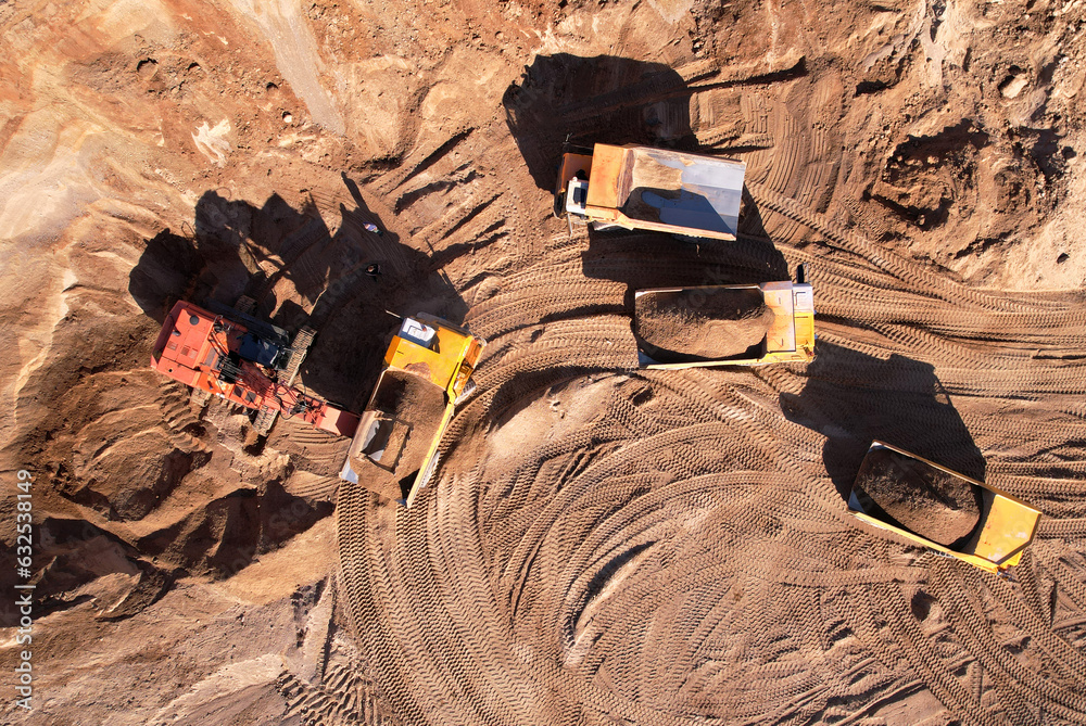 Excavator load sand in mining truck in opencast, top view. Mining ...