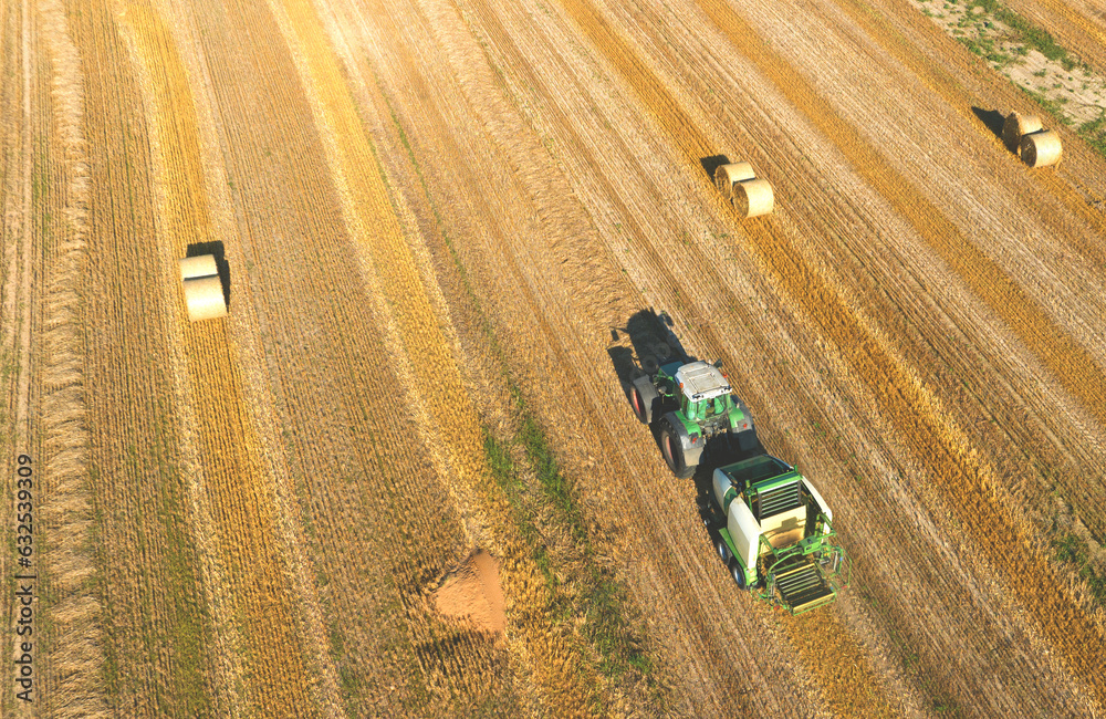 Hay making in field. Tractor with round baler. Making Hay Bales in an ...