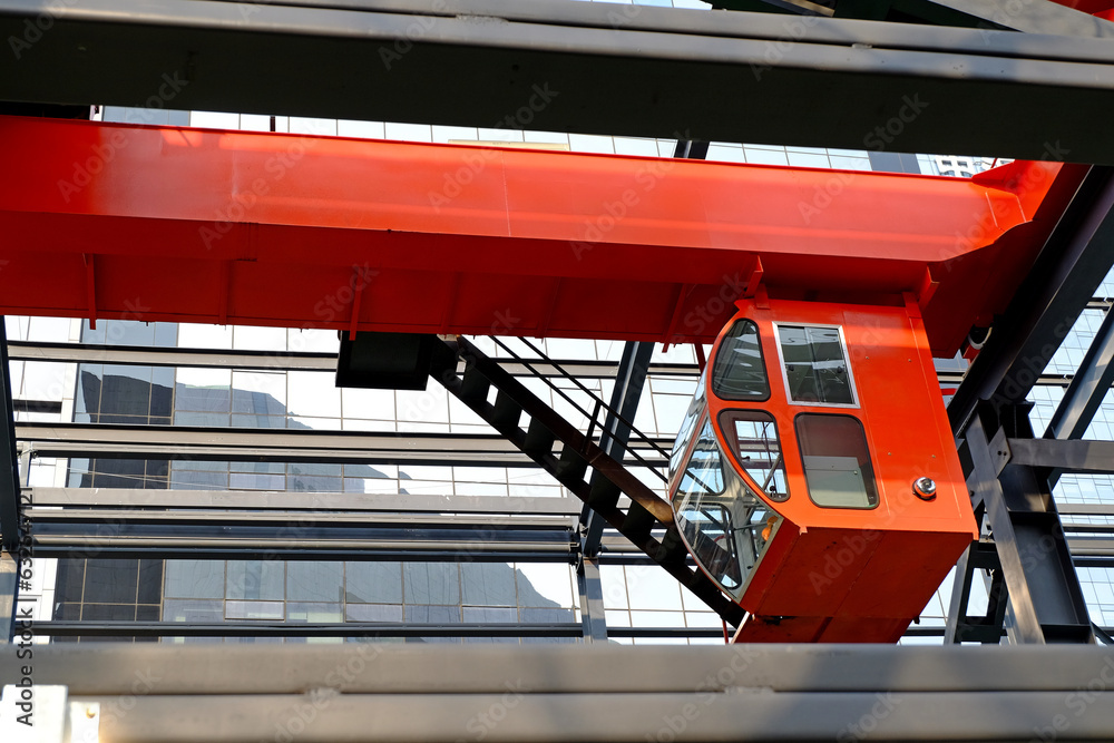 Overhead crane with an operator's cabin in the workshop of a machine ...