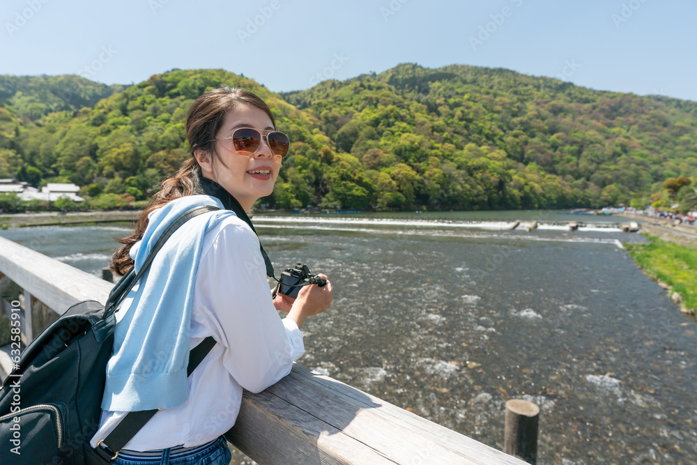 smiling fashionable asian Japanese girl tourist enjoying scenic view ...