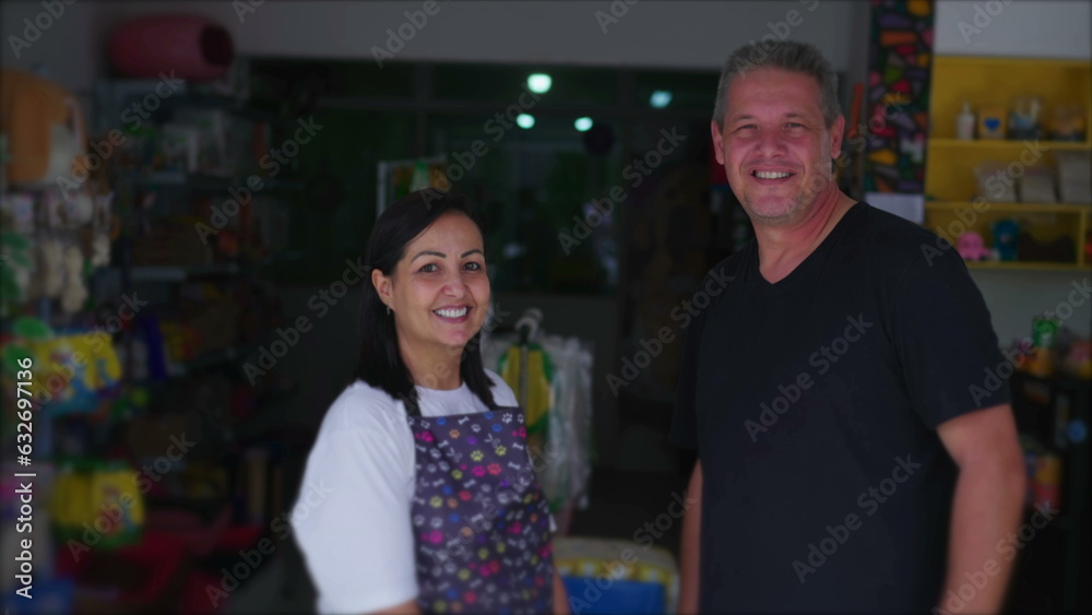 Pet Shop Owner and Customer posing for camera in front of Local Small ...