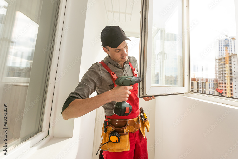 The worker installing and checking window in the house Stock Photo ...