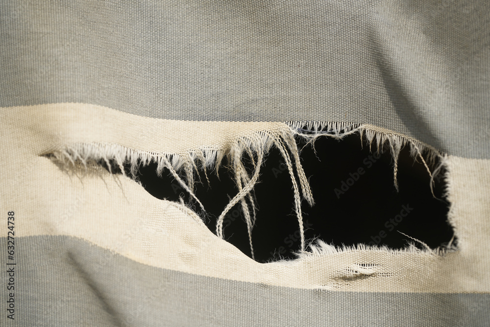 hanging teared rag spread isolated on black background , can use like a ...