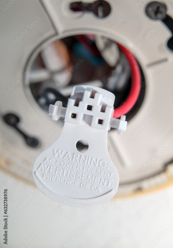 Smoke detector mounting base and plug with wires and warning label ac ...