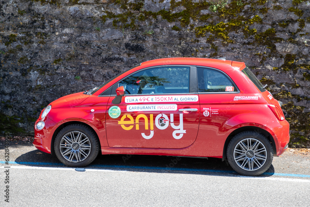 enjoy eni brand text and logo sign on side of city rent car sharing ...