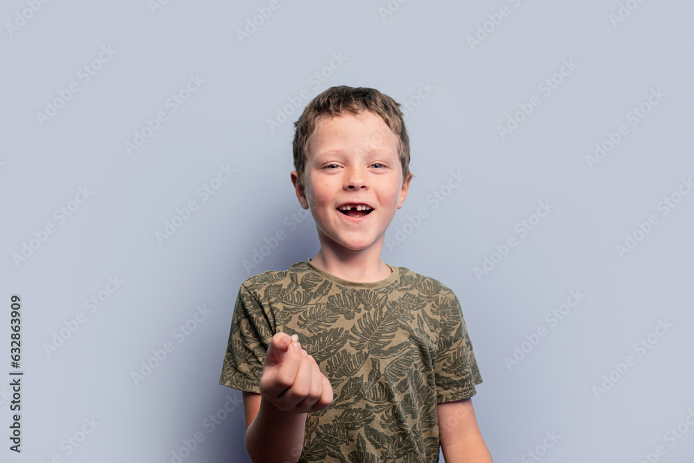 Kid losing his baby teeth. Boy with temporary baby tooth. Happy child ...