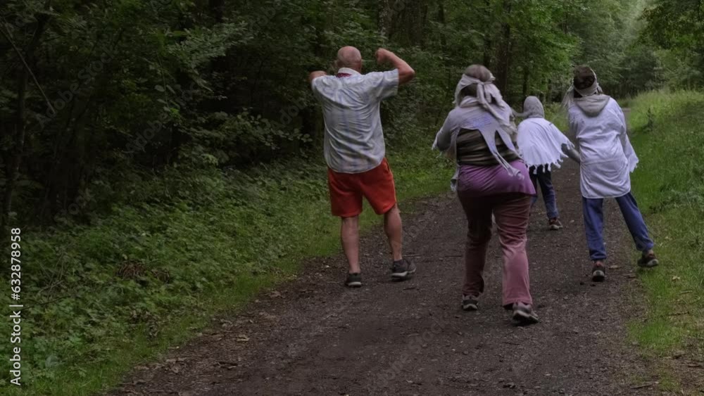 horror-filled zombie family walks through green forest, monster limbs ...