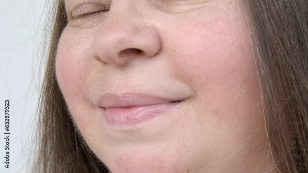 close-up of charismatic mature woman 50 years old looks carefully ...