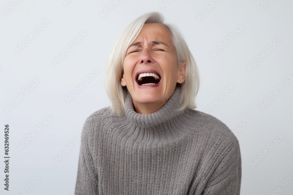 Medium shot portrait photography of a woman in her 50s wincing with ...