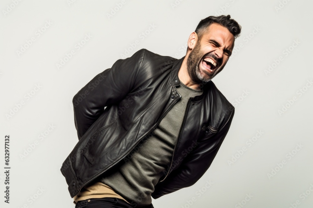 Lifestyle portrait photography of a man in his 30s wincing with pain ...