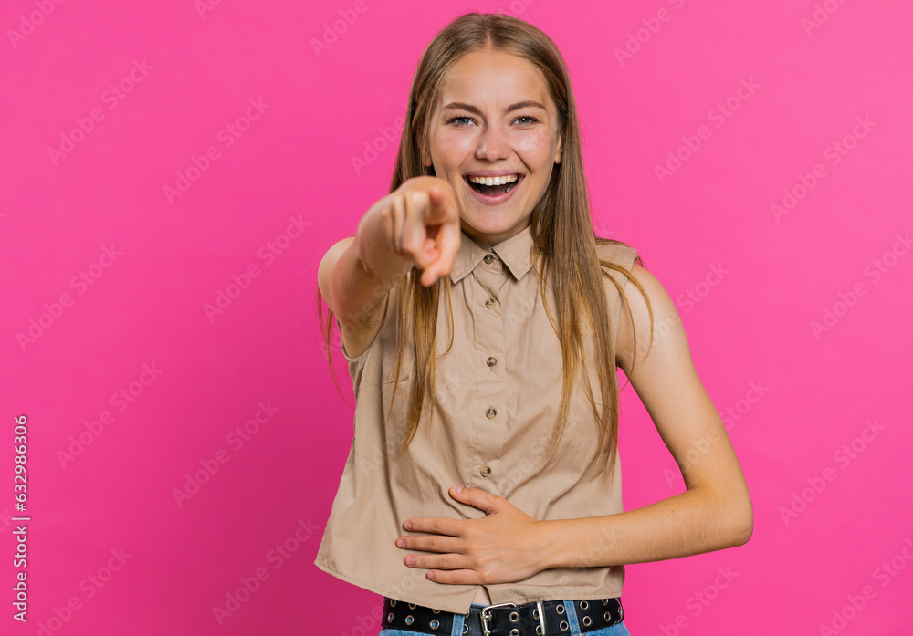 Amused lovely woman pointing finger to camera, laughing out loud ...