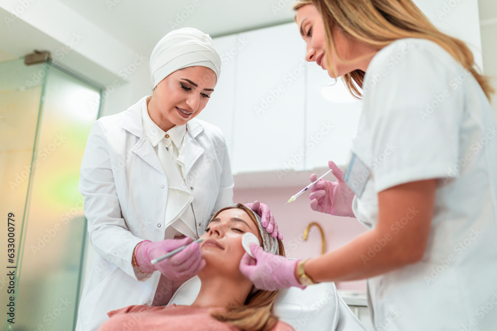 Cosmetologist drawing contour lines on the female's face before brow ...