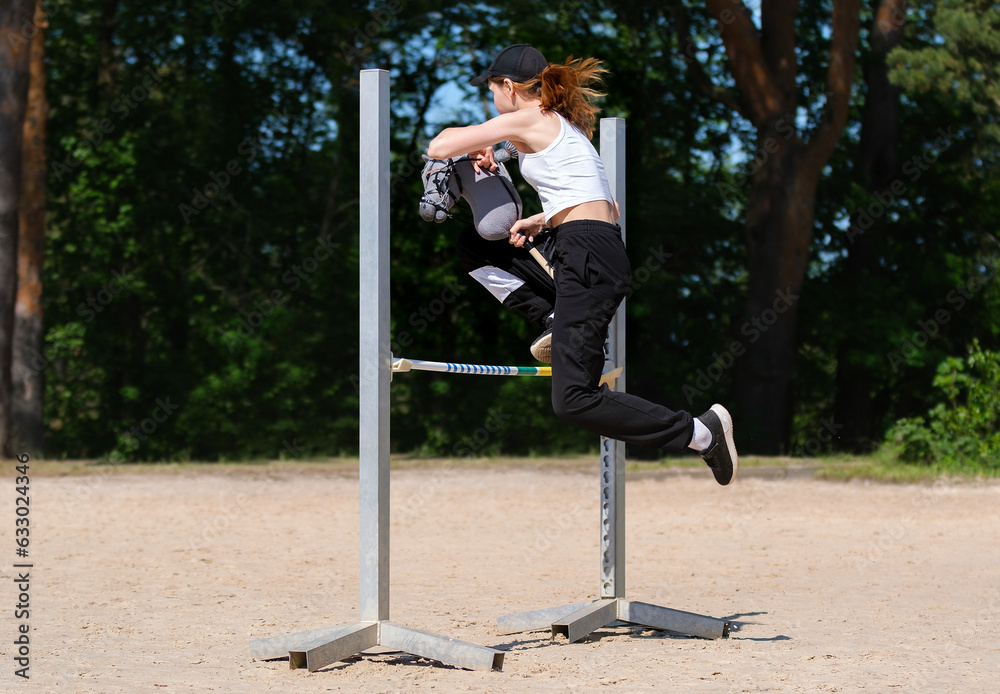 Girl jumping on hobby horse. Champion. Horse sport. Summer light. Green ...