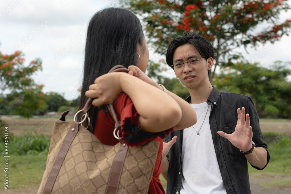 A young man tries to reason with his irate girlfriend who threatens to ...