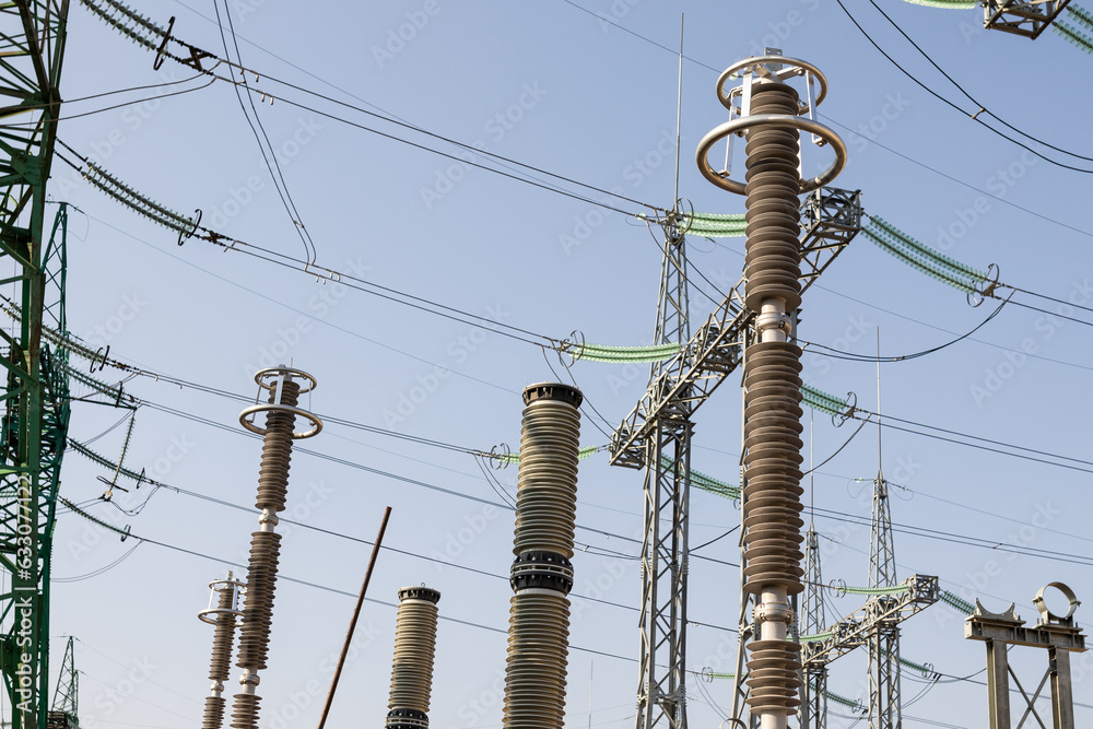 A high-voltage power electrical substation. Power lines, poles, ceramic ...