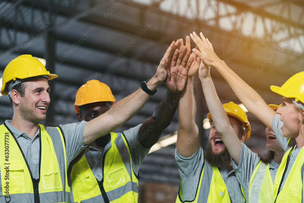 Group of diverse warehouse workers join hands together in storage ...
