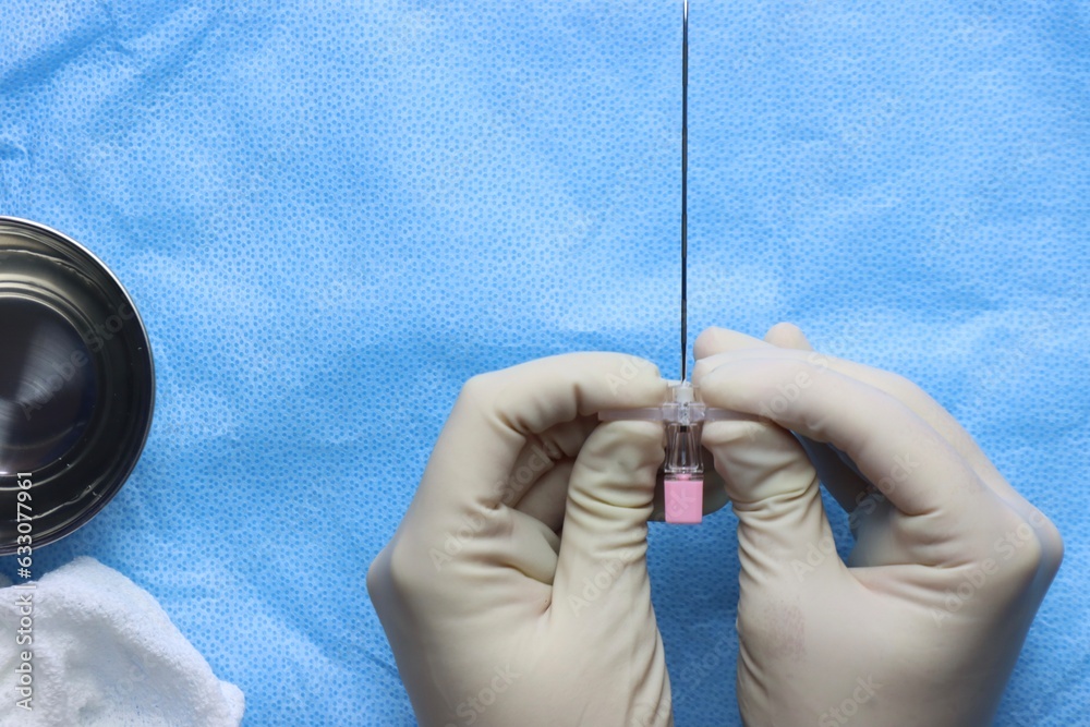 Poster Epidural catheter in a healthcare professional hands wearing ...