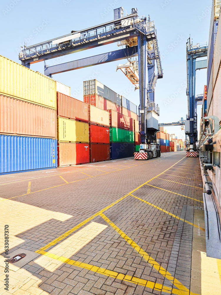 Shipping containers and cargo crane in dockyard, Felixstowe, England ...