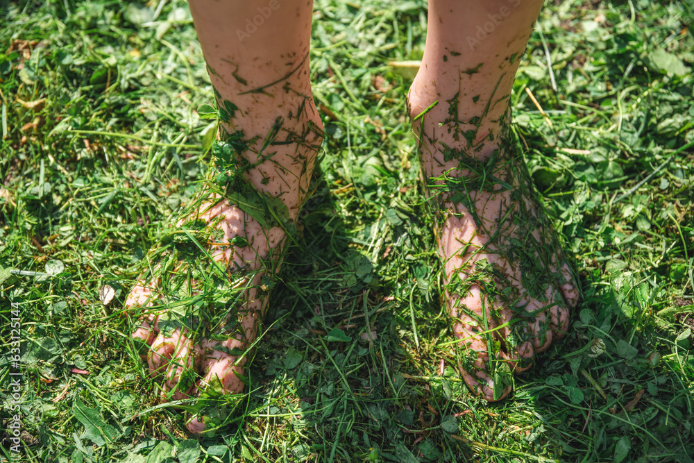 The concept of summer, ecology. unity with nature. bare feet in the ...