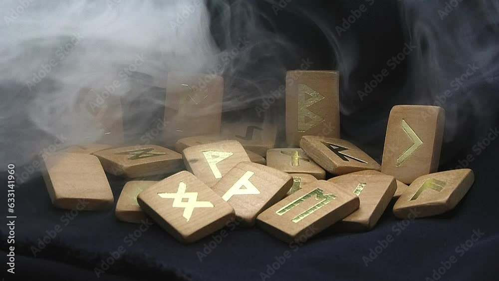 Vidéo Stock Wooden runes lie on a black background are shrouded in gray ...